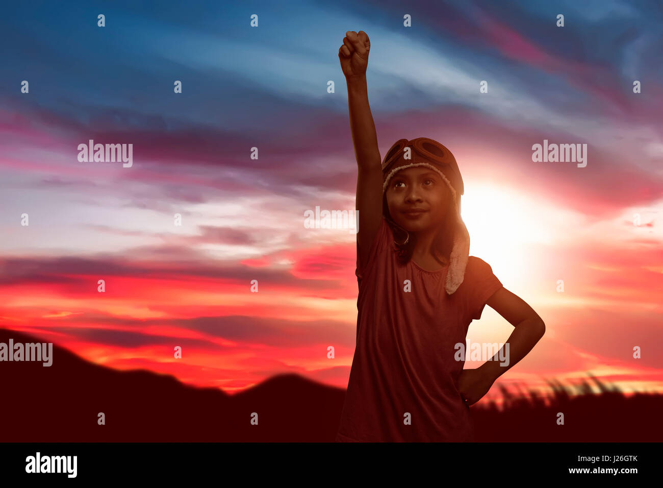 Funny asian kid with aviator helmet and act like a spaceman at sunset ...