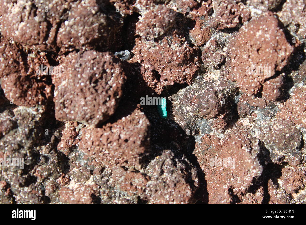 Fragments of plastic pollution on volcanic rock Stock Photo - Alamy