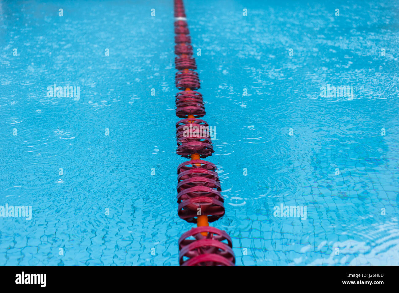 Swimming pool with red floats and clear blue water Stock Photo - Alamy