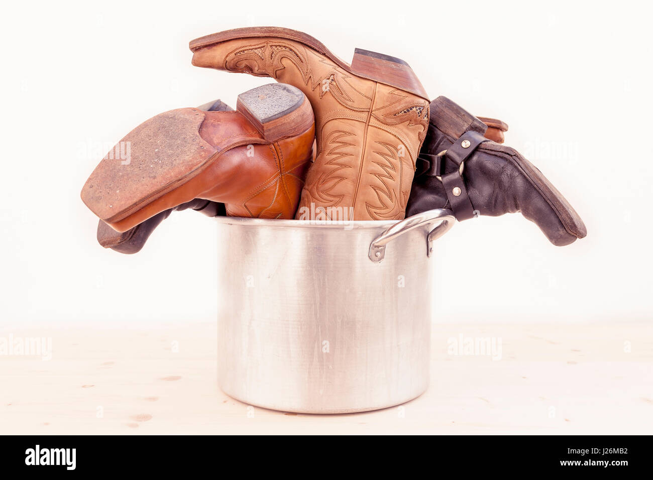 vintage cowboy boots inside a kitchen pot Stock Photo - Alamy
