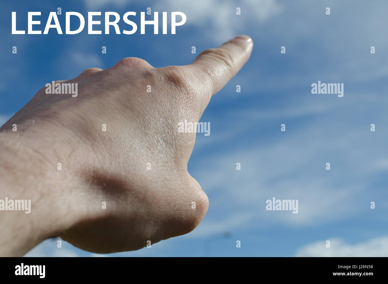 Finger pointing towards blue sky leadership concept Stock Photo - Alamy
