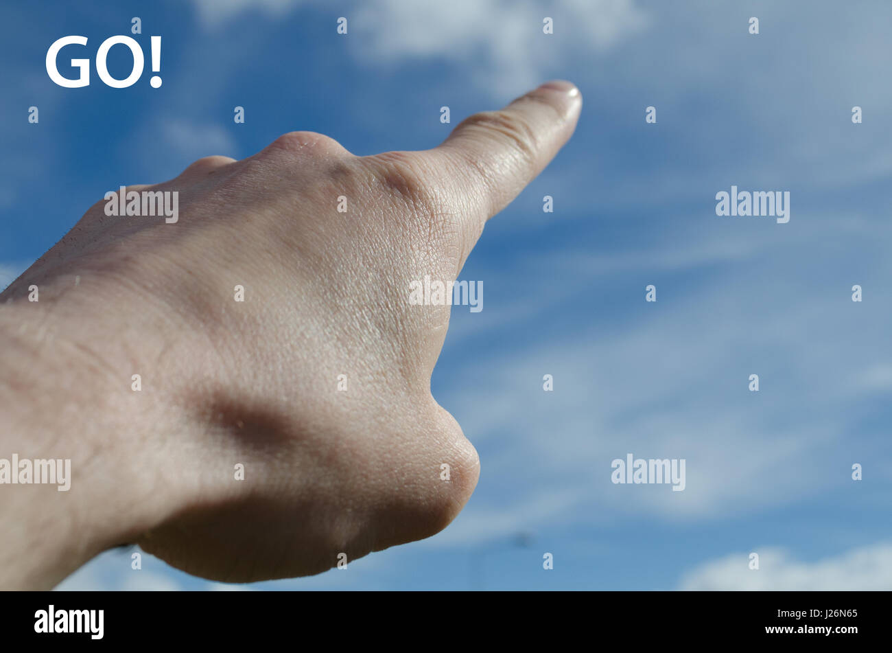 Finger pointing towards blue sky go concept Stock Photo - Alamy