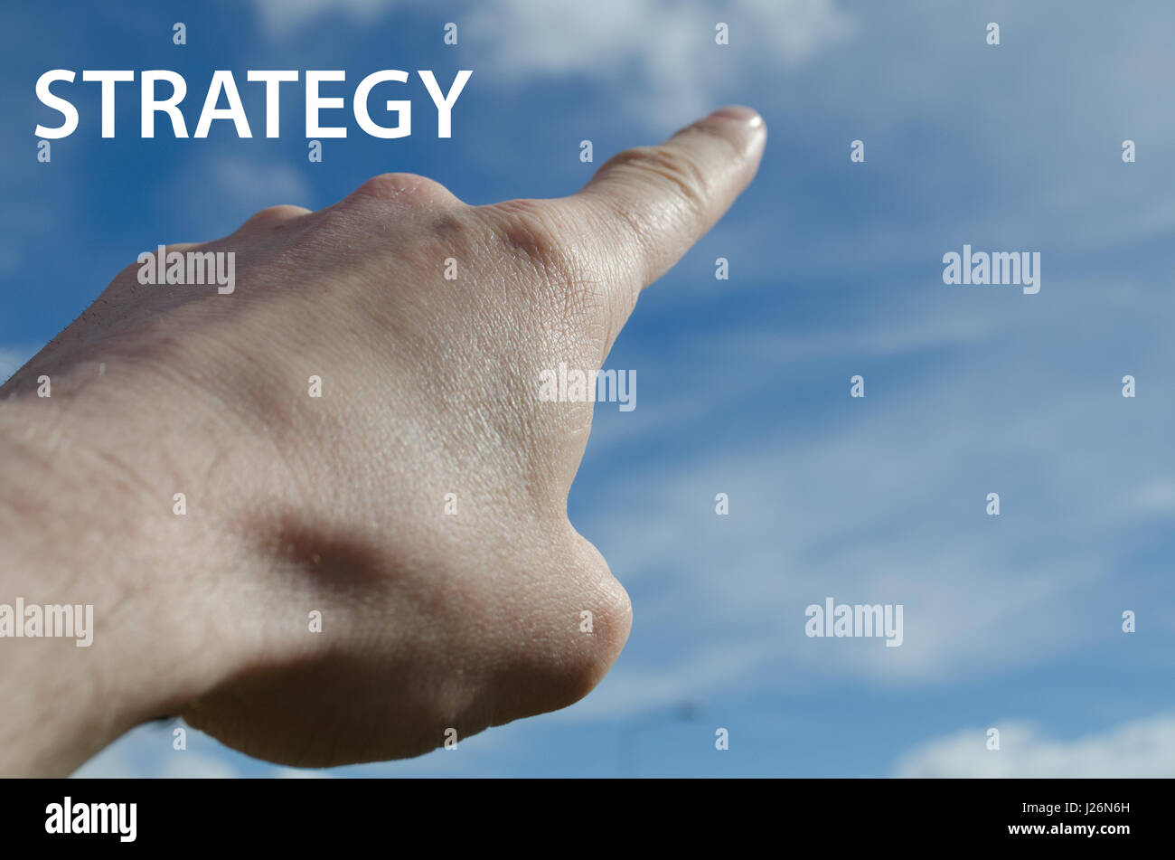 Finger pointing towards blue sky strategy concept Stock Photo - Alamy