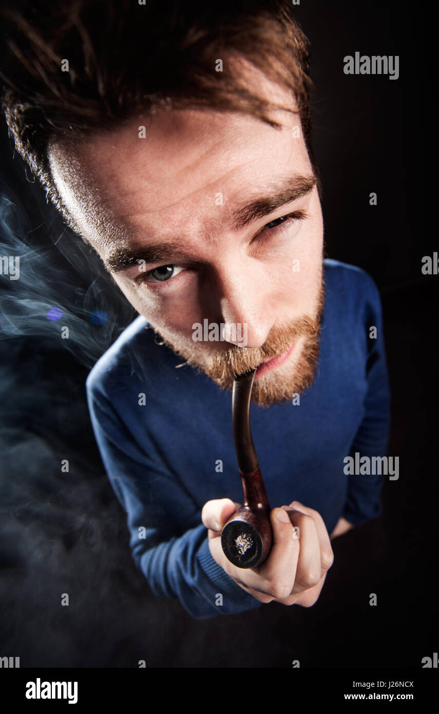Funny handsome man smoking pipe.Wide angle shoot Stock Photo - Alamy