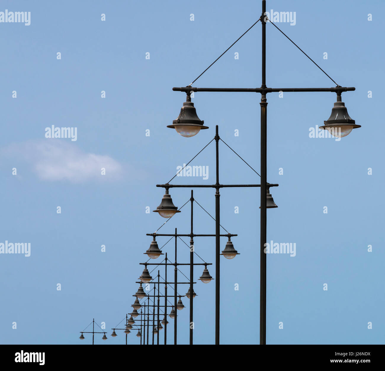 Geometric row of lamp posts in Fuerteventura, Spain with blue sky ...