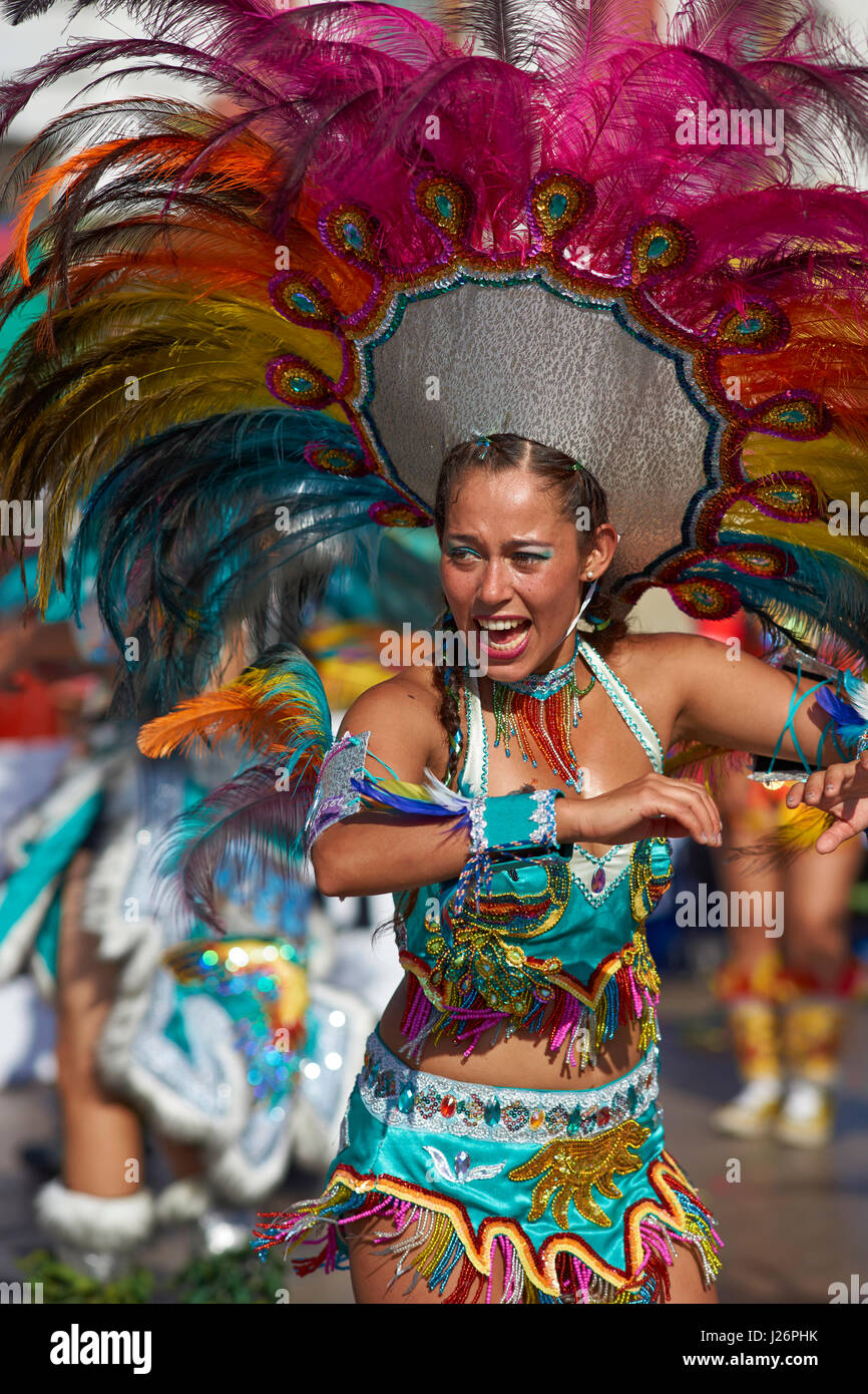 Female member of a Tobas dance group in ornate costume performing at ...