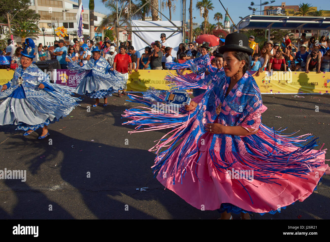 Female members of a Morenada dance group in ornate costumes performing ...