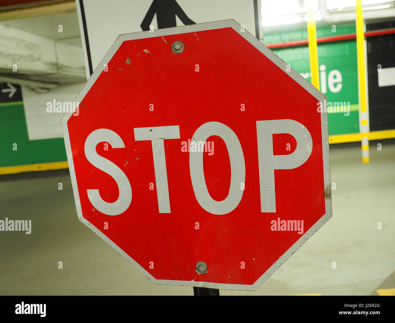 Stop sign in an underground parking in Montreal Stock Photo - Alamy