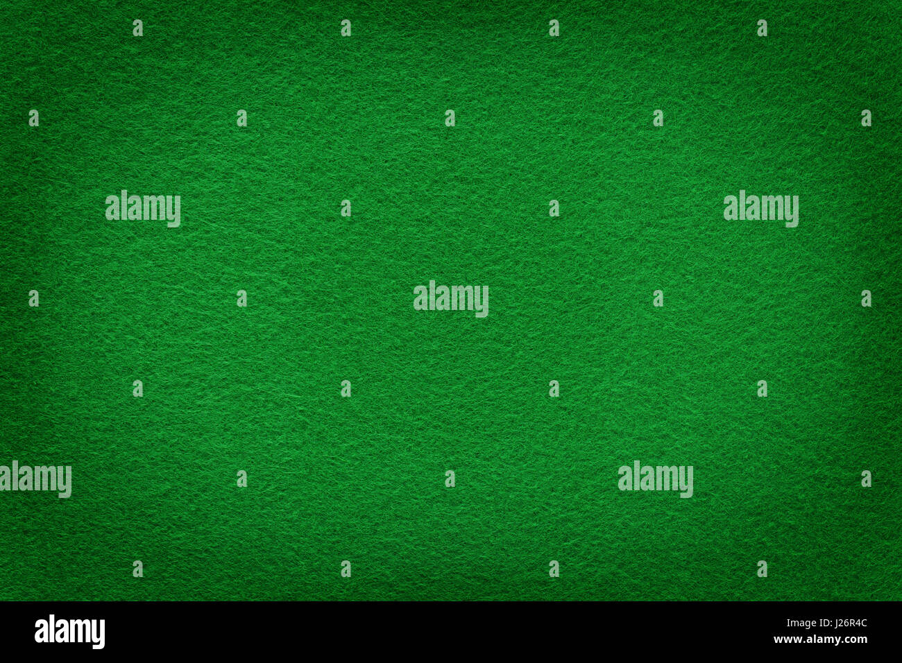 Green felt surface with light copy space in center. Texture and ...