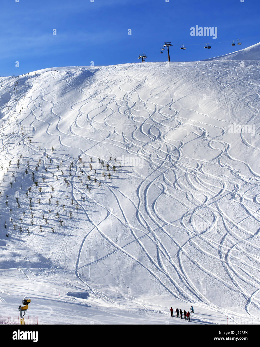 Off-piste slope with trace from ski and snowboard at sun morning ...