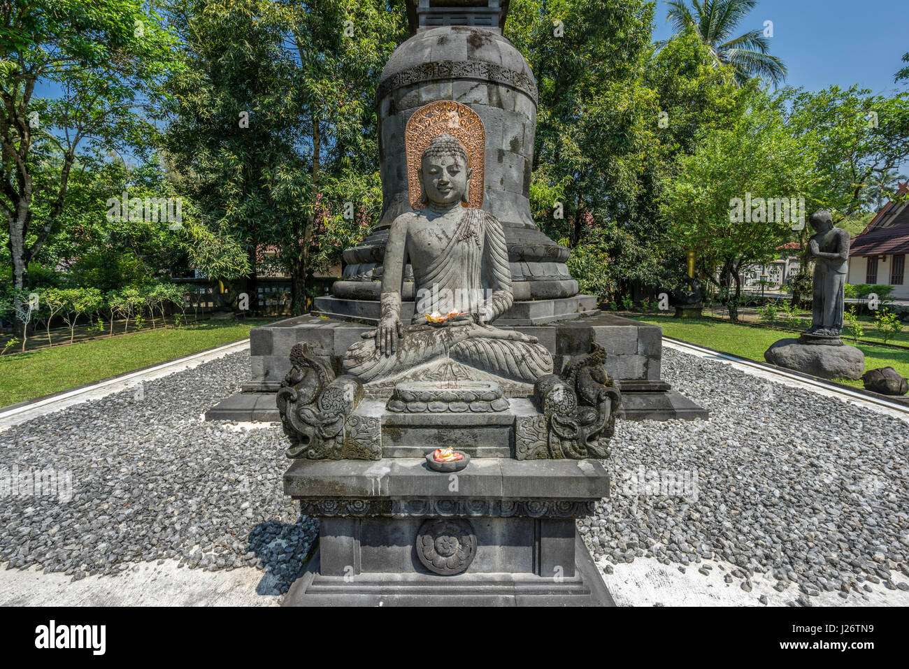 Buddha stone statue in the Bhumisparsha Mudra or gesture. Mendut ...