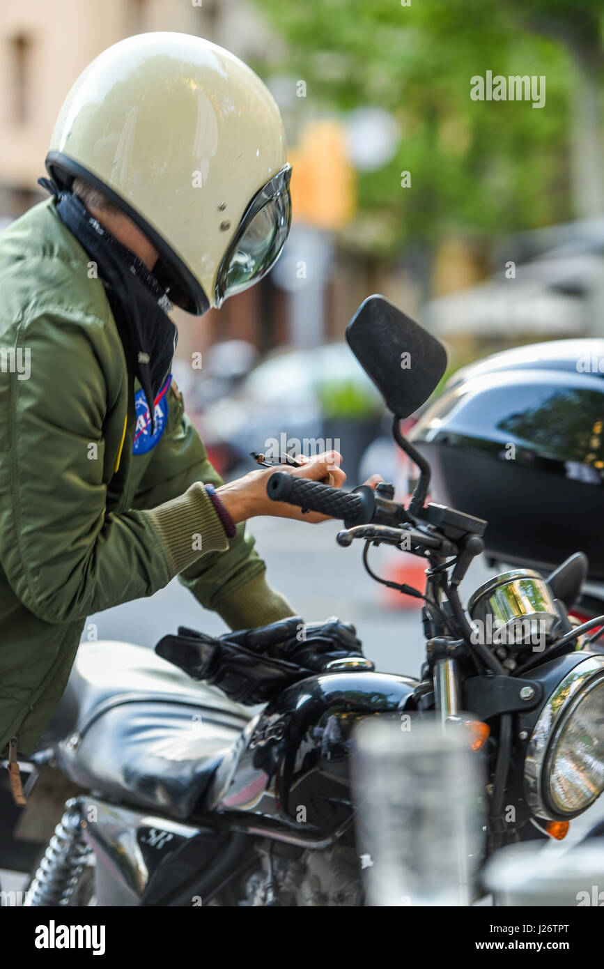 Guys on a motorcycle with helmets on Stock Photo - Alamy
