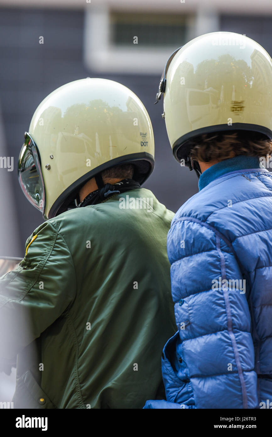 Guys on a motorcycle with helmets on Stock Photo - Alamy