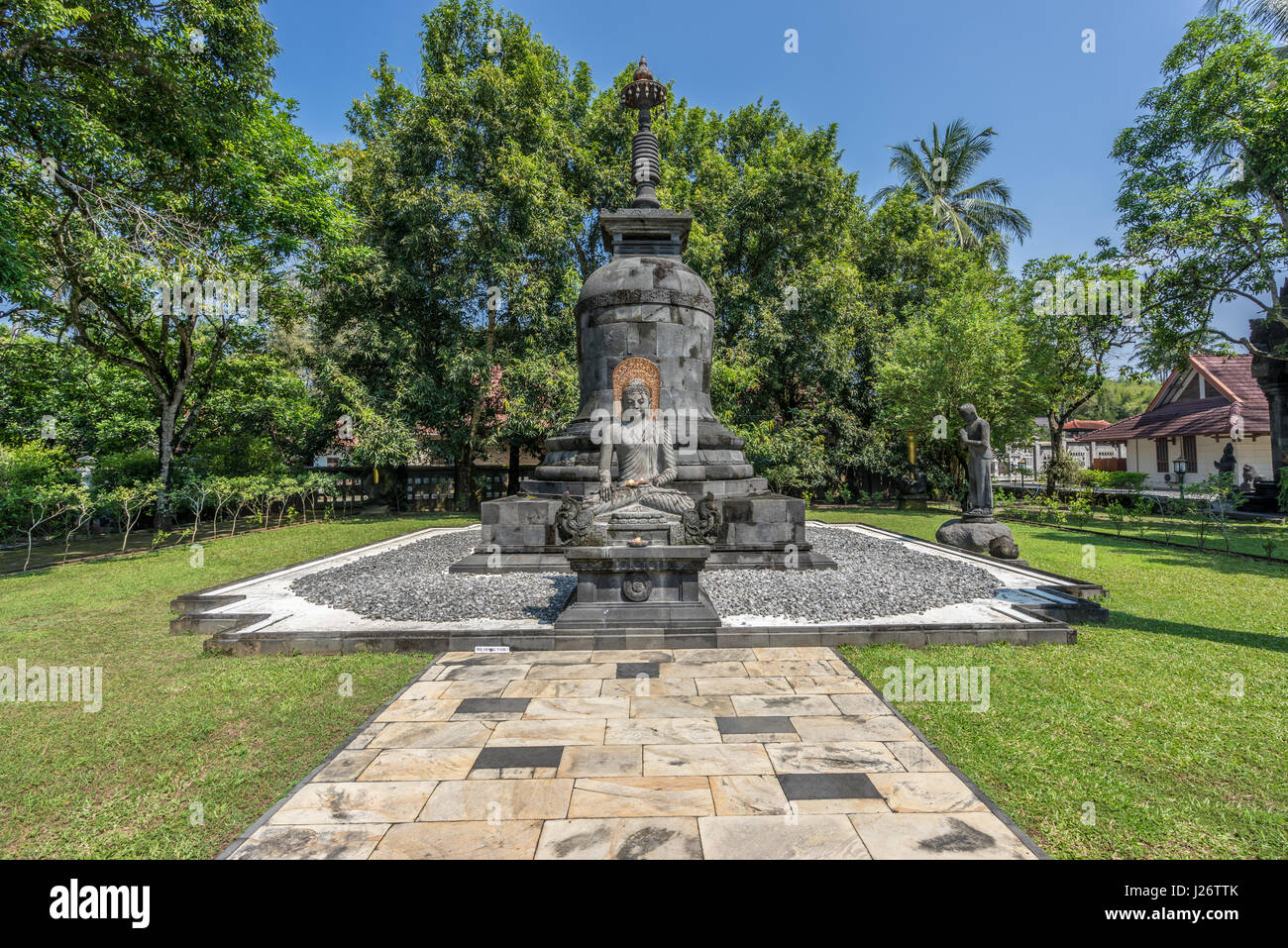 Buddha stone statue in the Bhumisparsha Mudra or gesture. Mendut ...