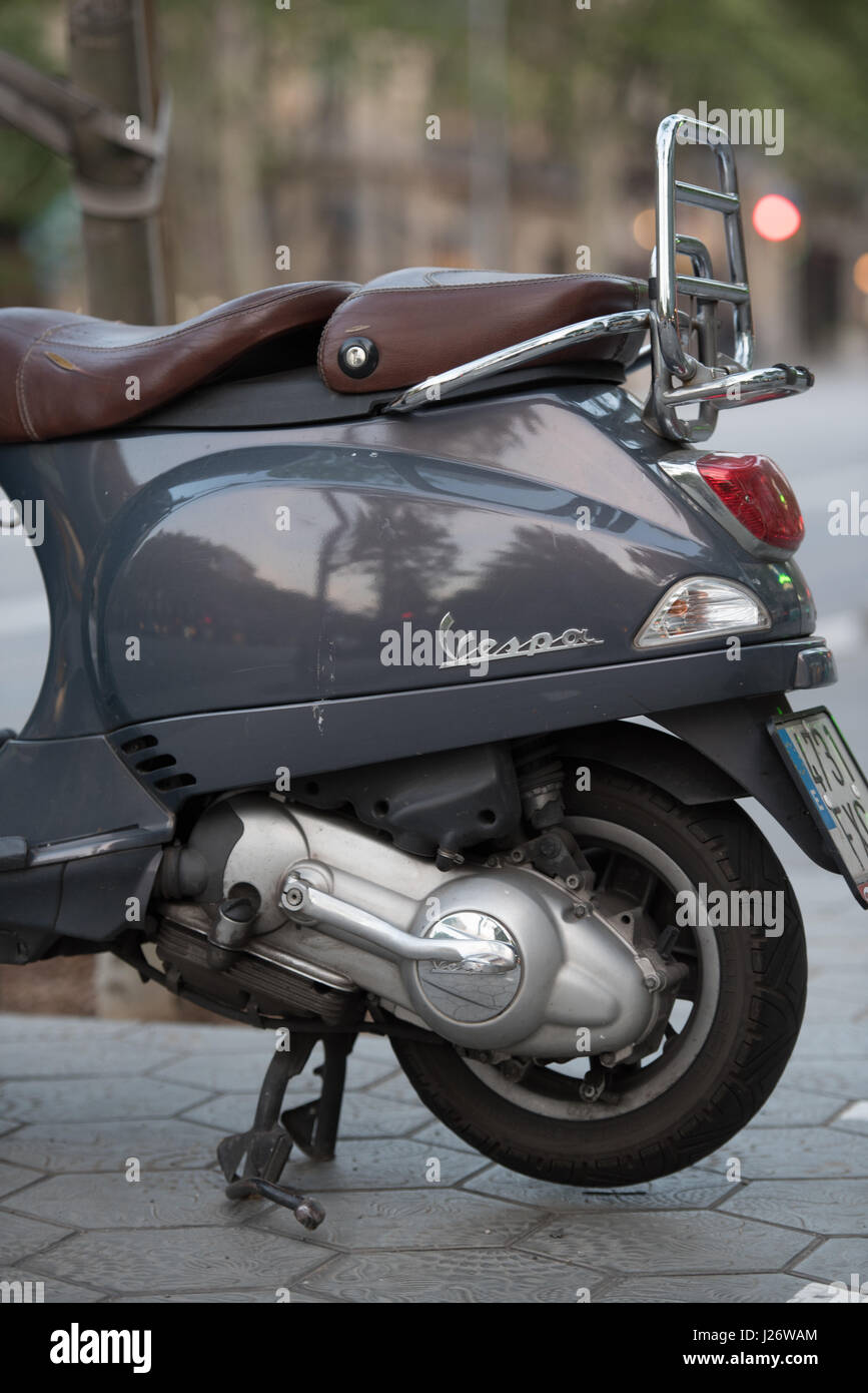 Scooter standing on street in Spain Stock Photo - Alamy