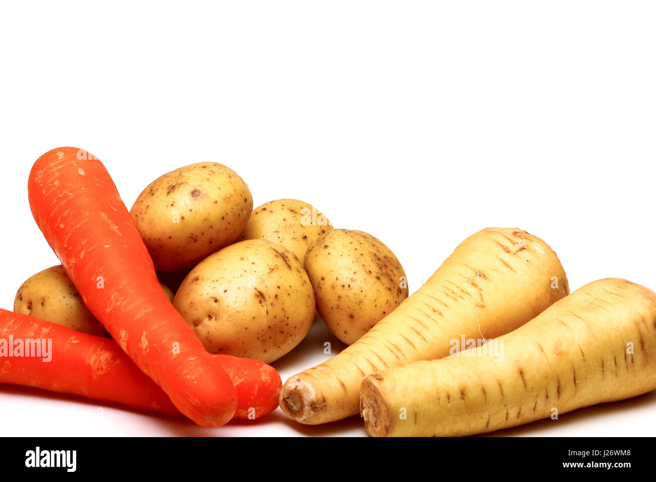 Collection of raw organic root vegetables including potatoes , carrots ...