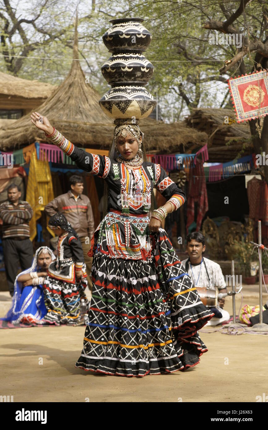 Female Tribal dancer performing a dance whilst balancing pots on her ...