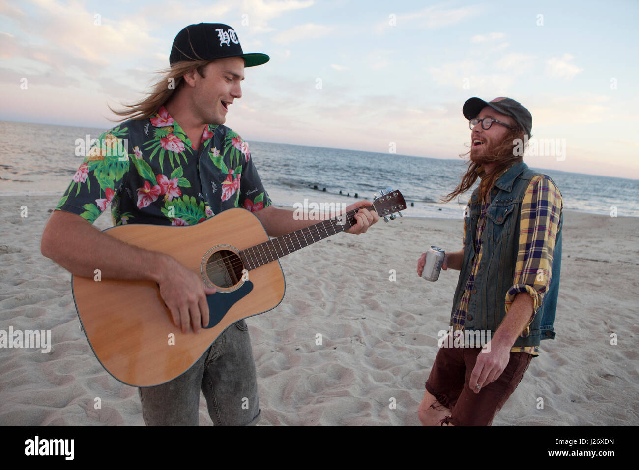 Playing guitar singing on beach hi-res stock photography and images - Alamy
