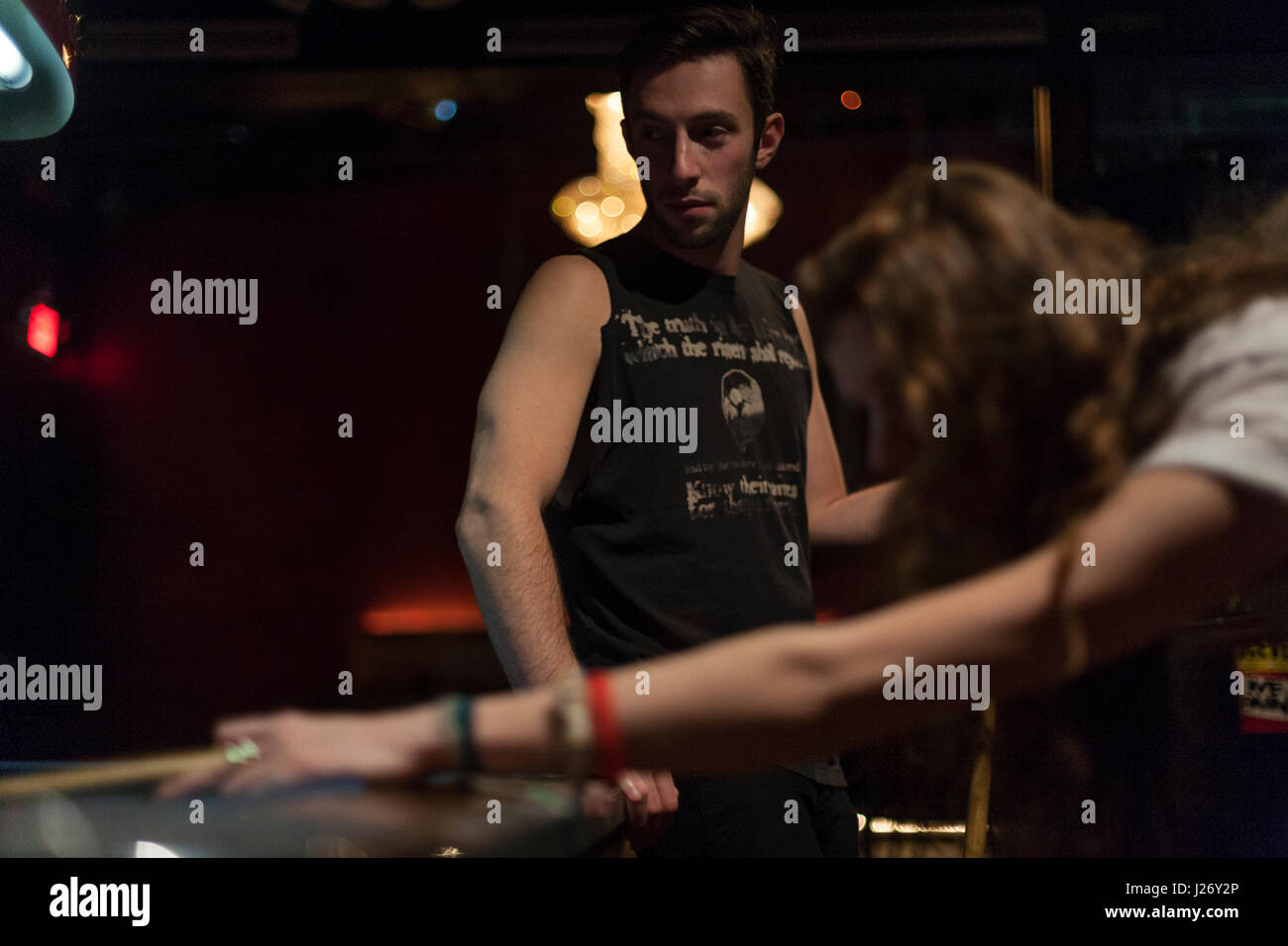 Young couple hanging out at a pool hall Stock Photo - Alamy