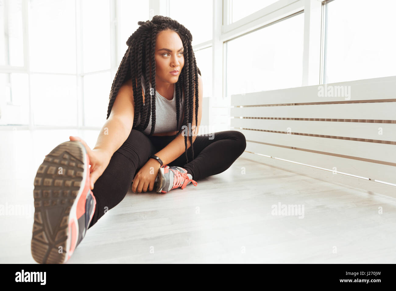Active curvy focused lady stretching her muscles Stock Photo - Alamy