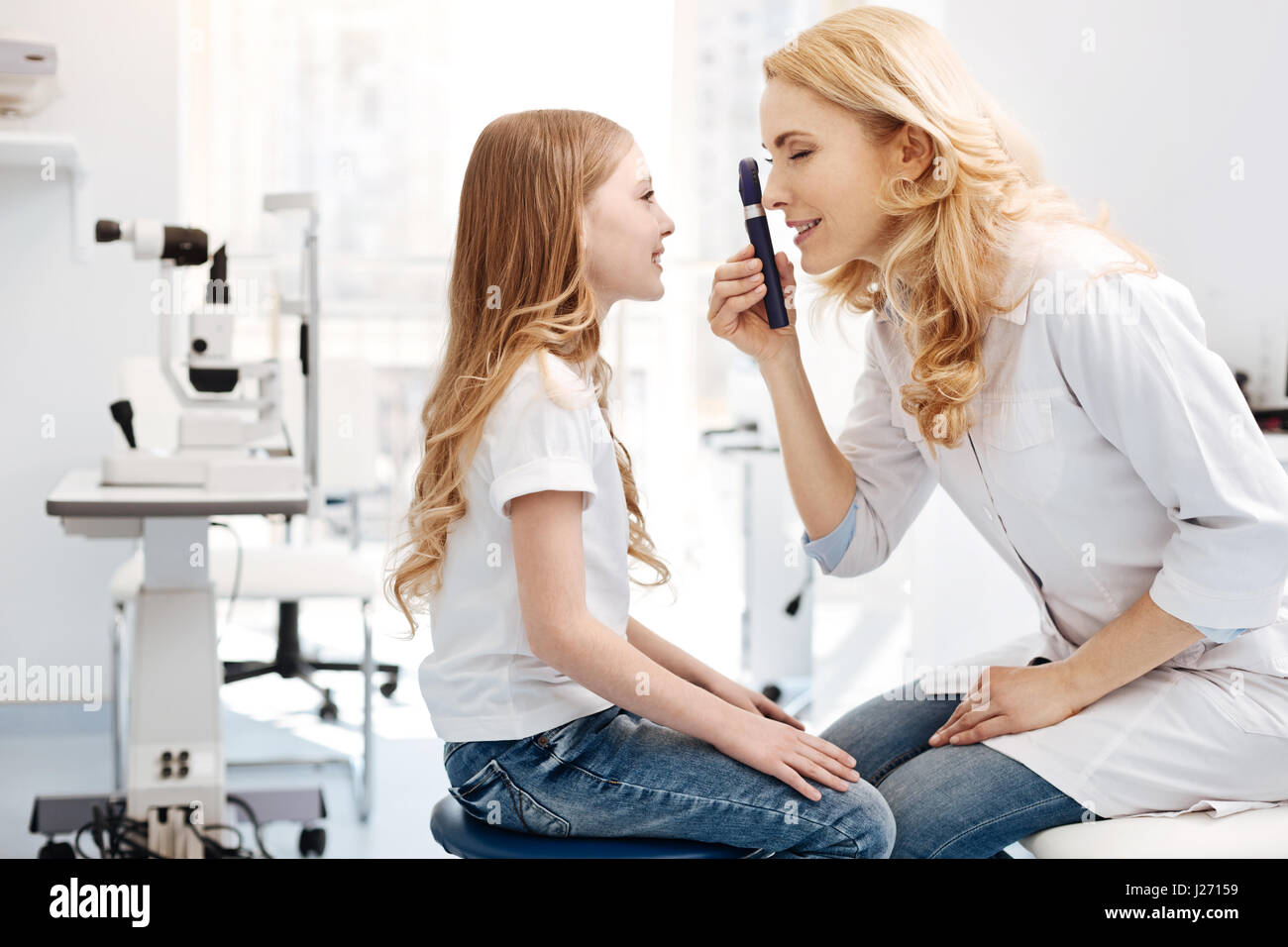 Capable private doctor running a routine checkup Stock Photo - Alamy