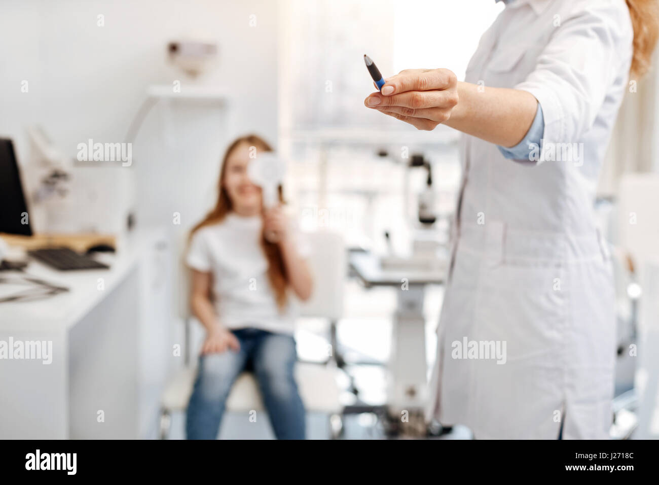 Active diligent girl doing an eye test Stock Photo - Alamy