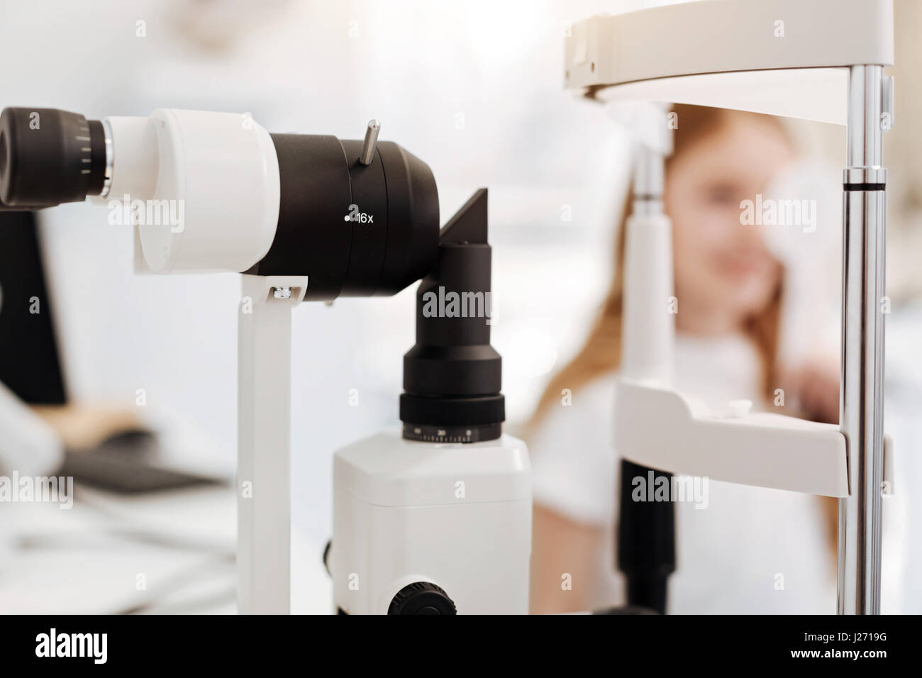 Distinguished optician having a lot of equipment in her office Stock ...
