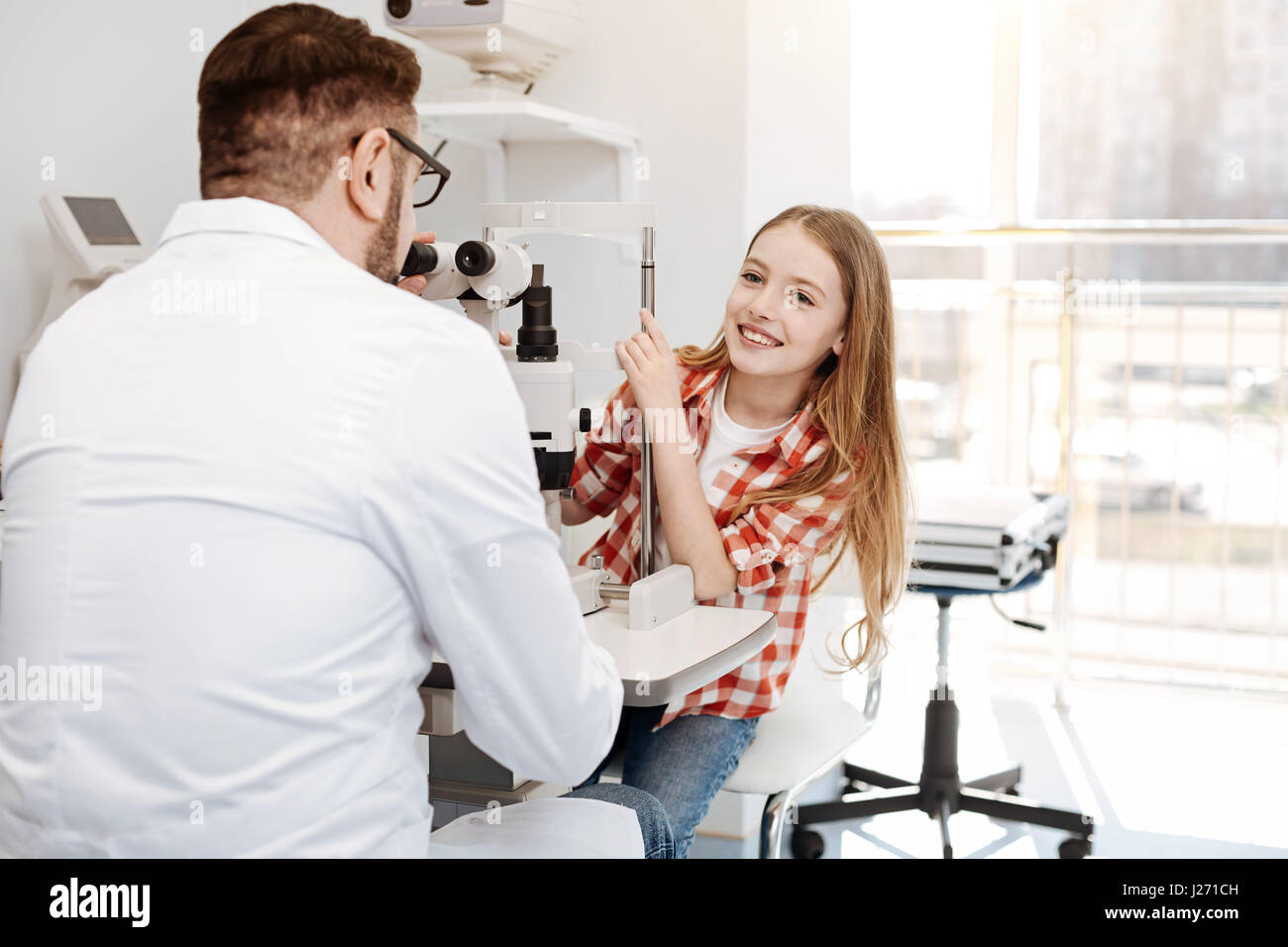 Positive bright child asking her doctor questions Stock Photo - Alamy