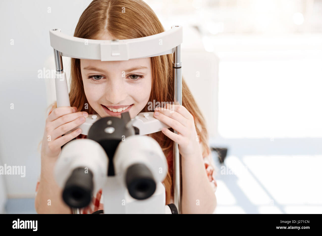 Young curious kid waiting for her eyesight test Stock Photo - Alamy