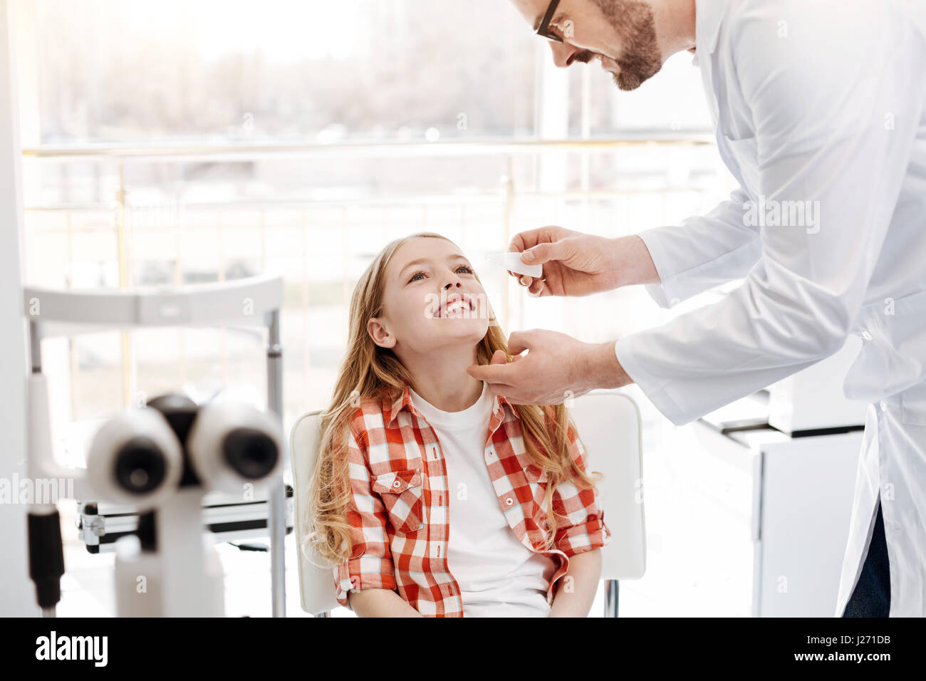 Careful prominent doctor instilling eyedrops Stock Photo - Alamy