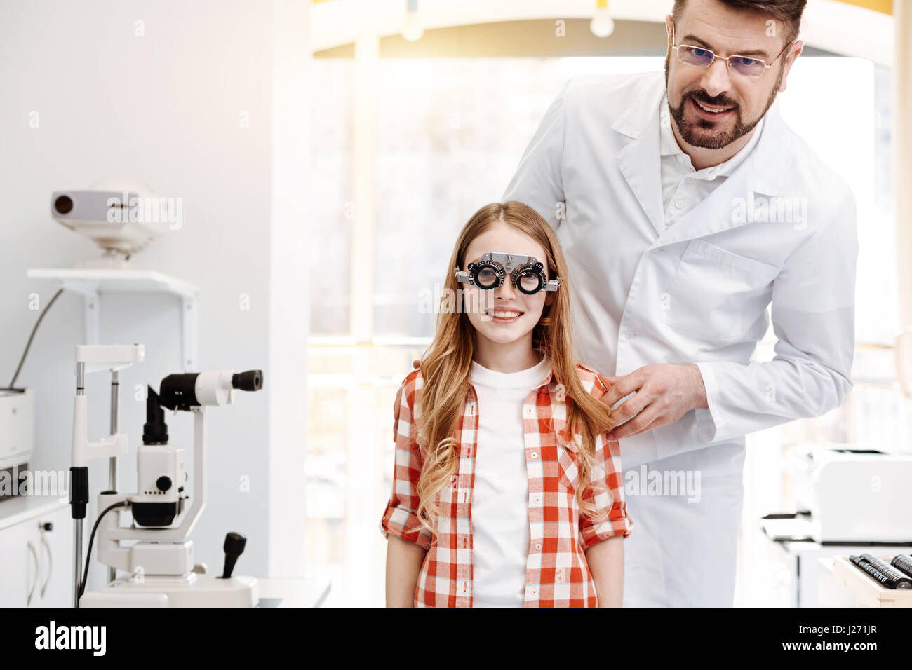 Regular skillful optician correcting lenses Stock Photo - Alamy