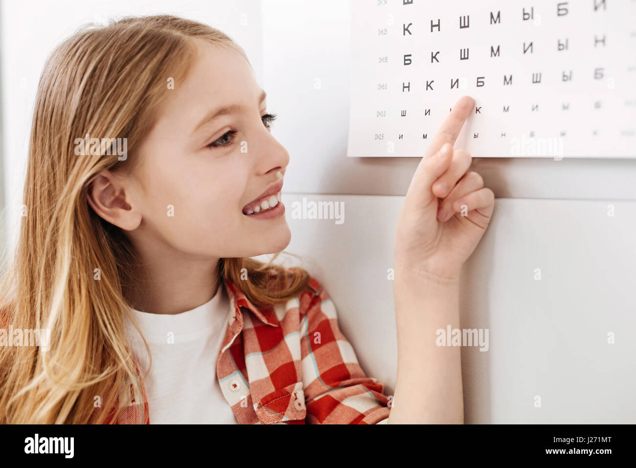 Curious child reading letters from doctors chart Stock Photo - Alamy