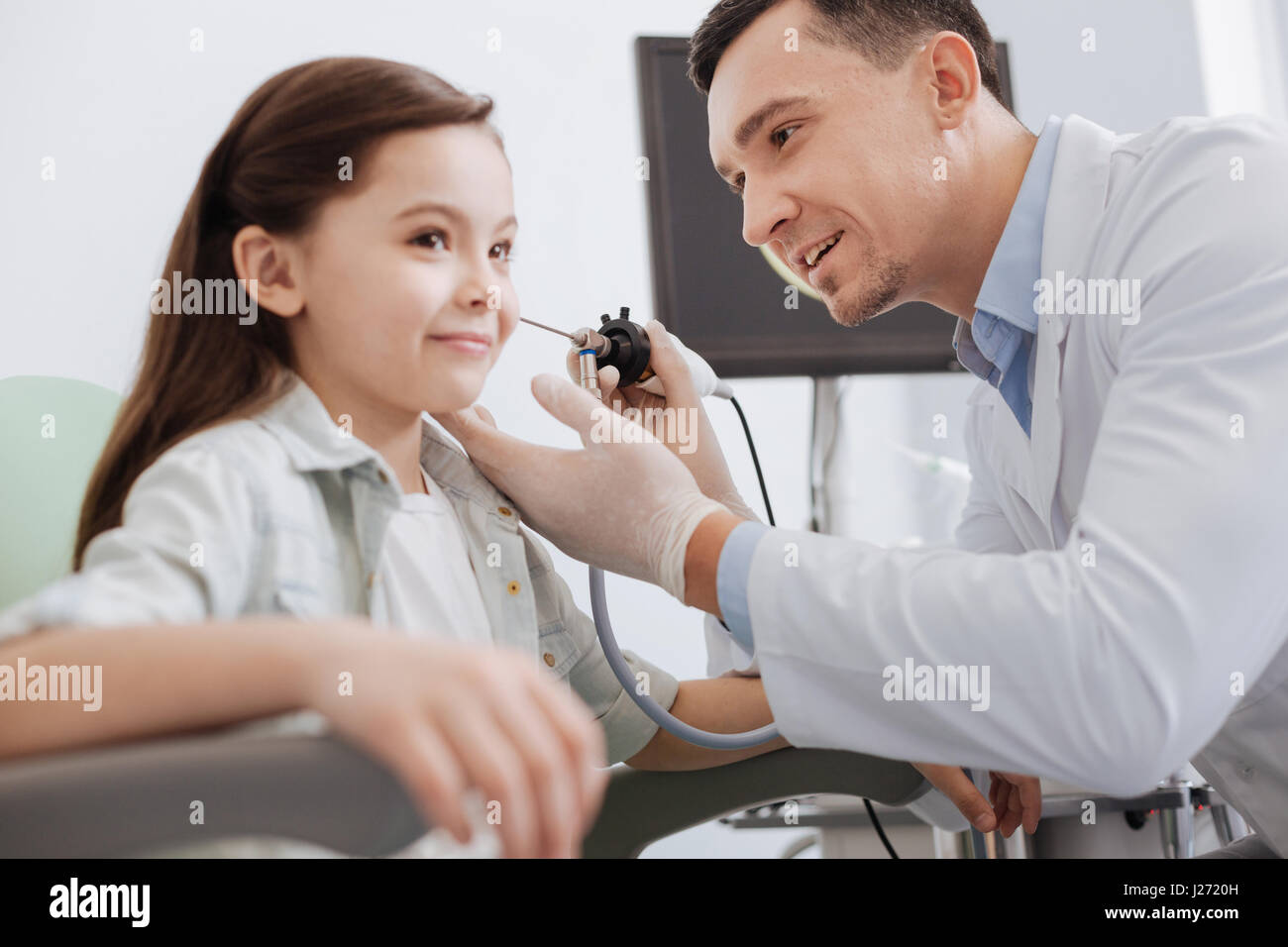 Close up of ENT doctor examining little girls ear Stock Photo - Alamy