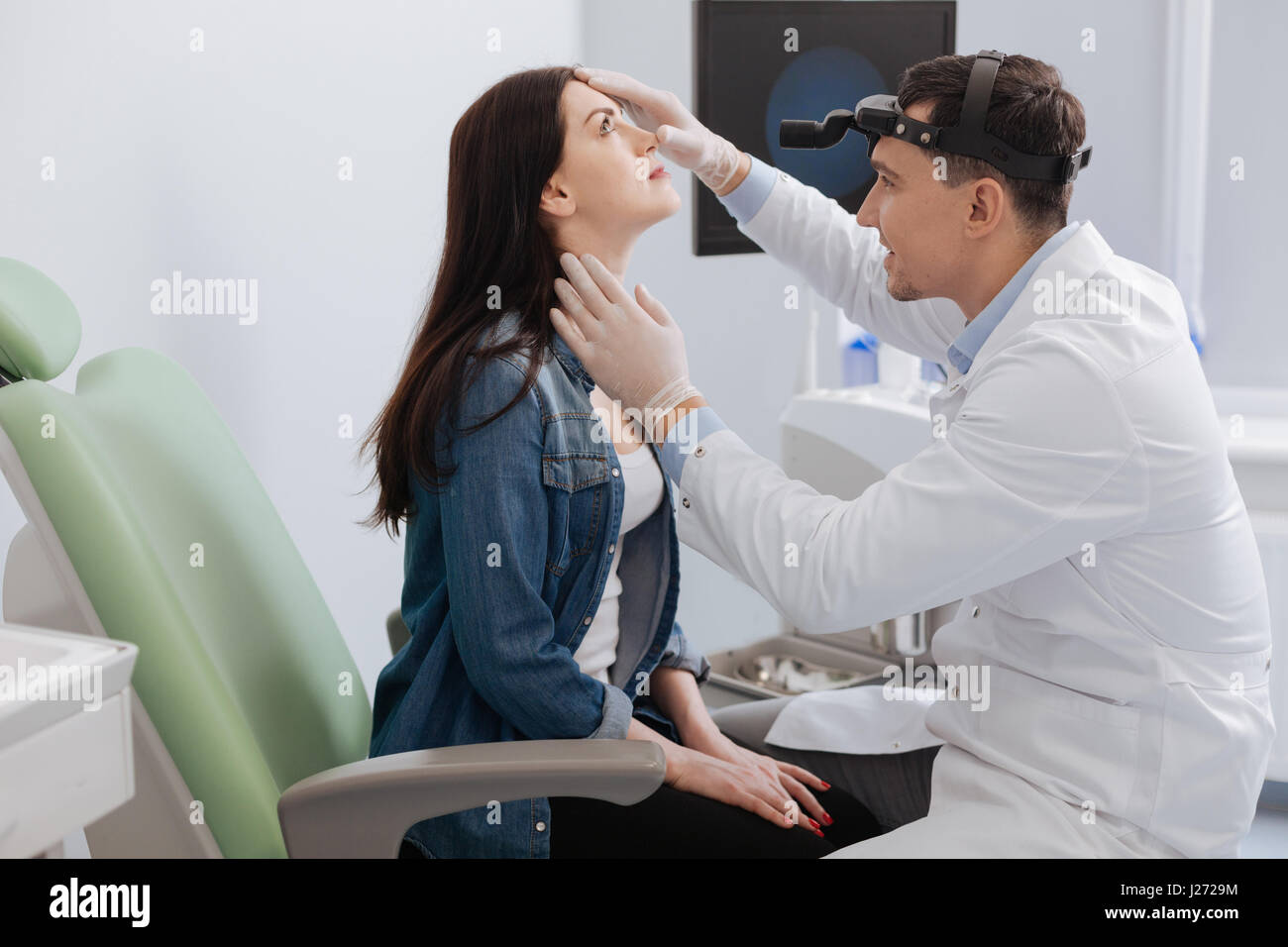 Rise your head. Handsome clever doctor wearing clean smock and rubber ...