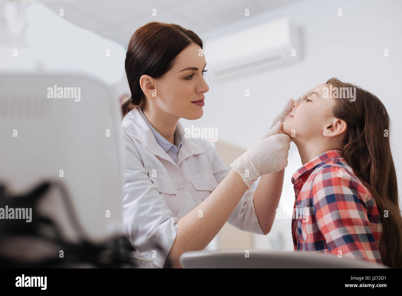 Attentive ENT doctor doing nose exam of her daughter Stock Photo - Alamy
