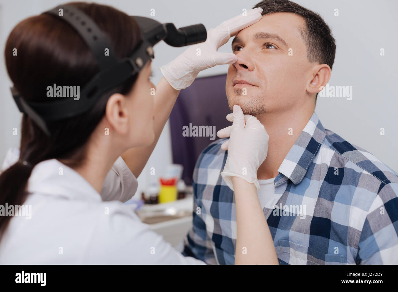 Nose and throat examination otoscope hi-res stock photography and ...