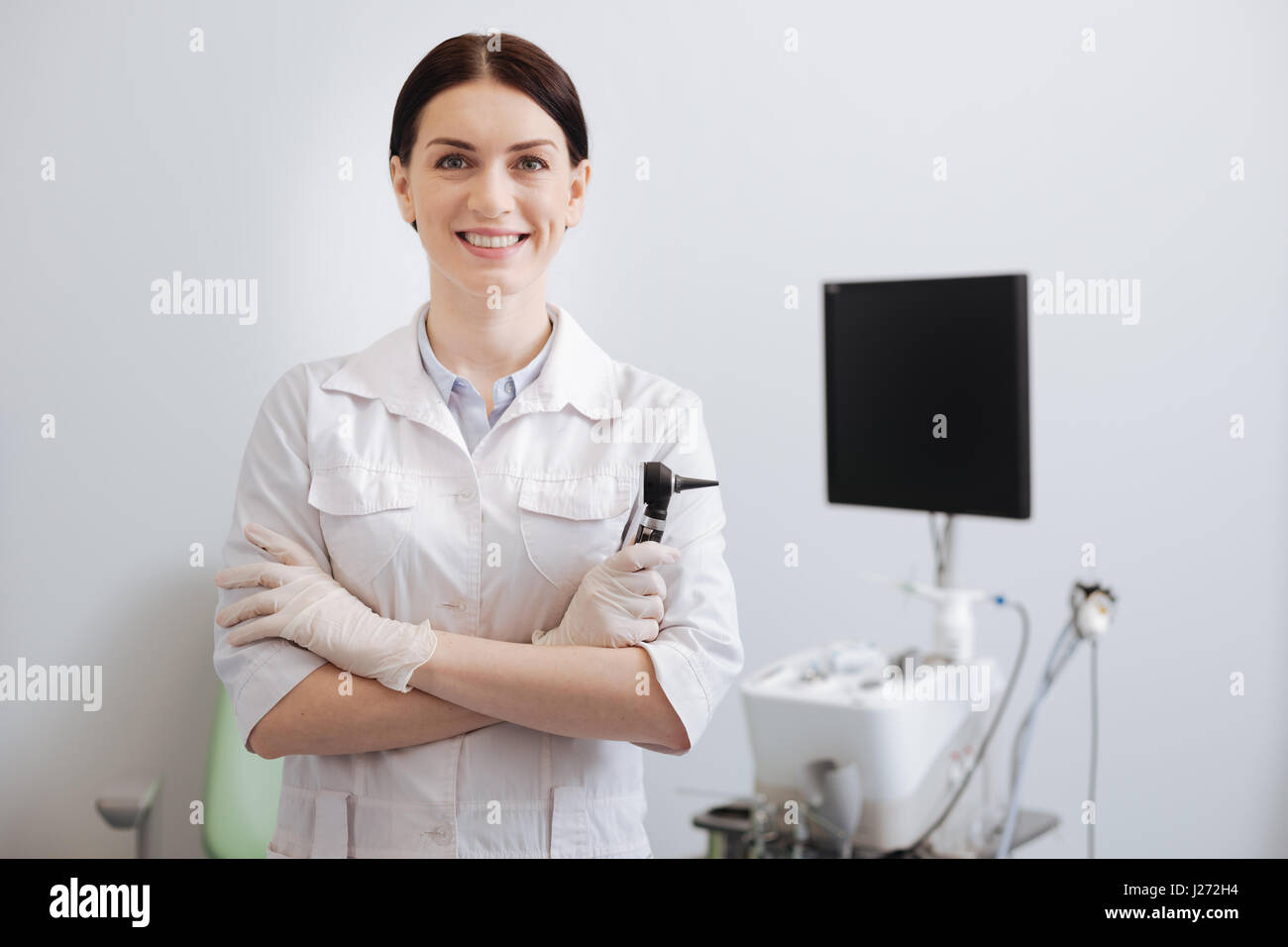 Positive delighted female otolaryngologist posing on camera Stock Photo ...