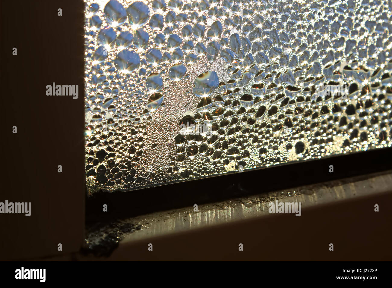 Reflection of morning sunlight through window condensation Stock Photo ...