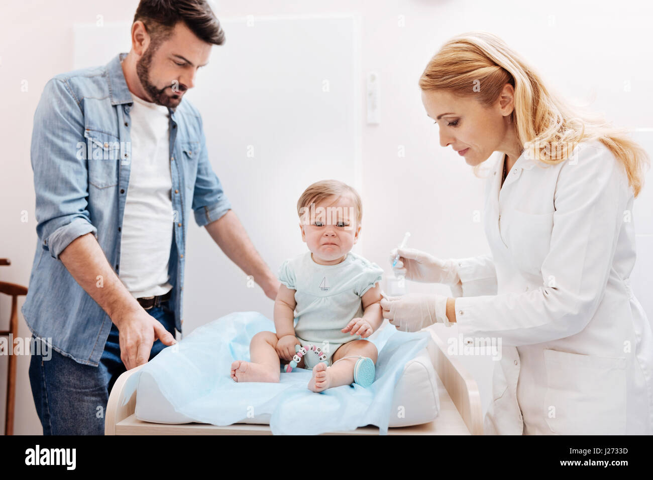 Crying baby looking straight at camera Stock Photo - Alamy