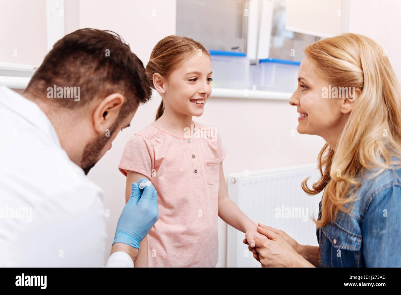 Brave child patient looking at her mother Stock Photo - Alamy