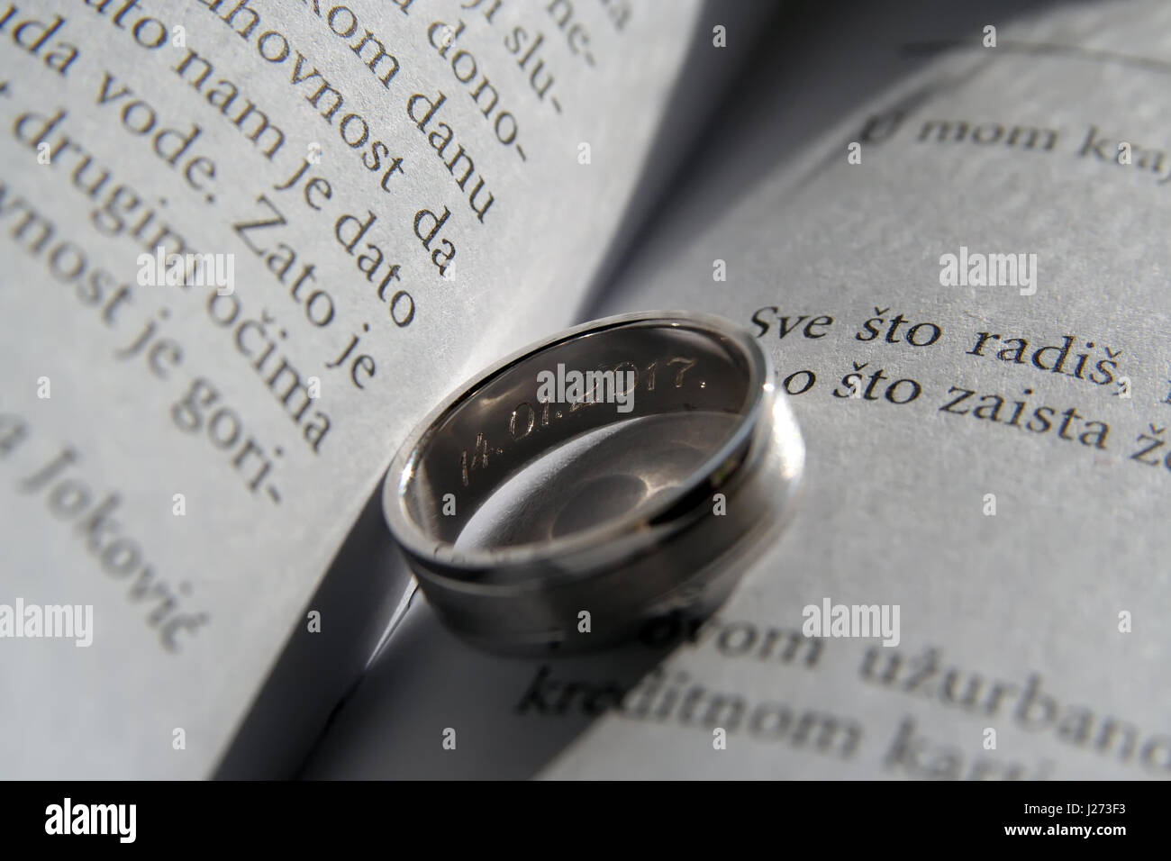 White gold ring. Wedding rings in a book Stock Photo - Alamy