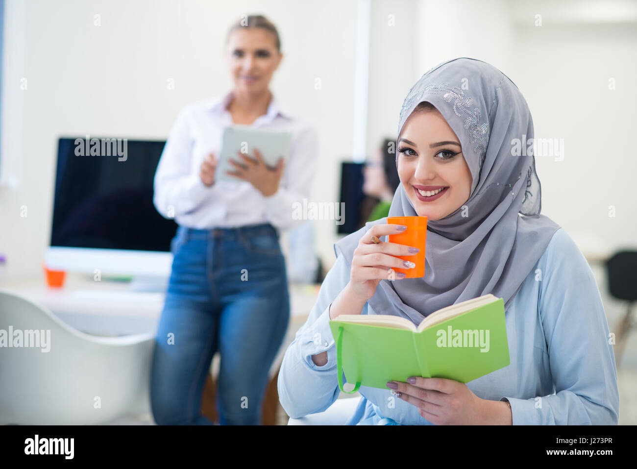 Arabic business woman working in team with her colleagues at startup ...