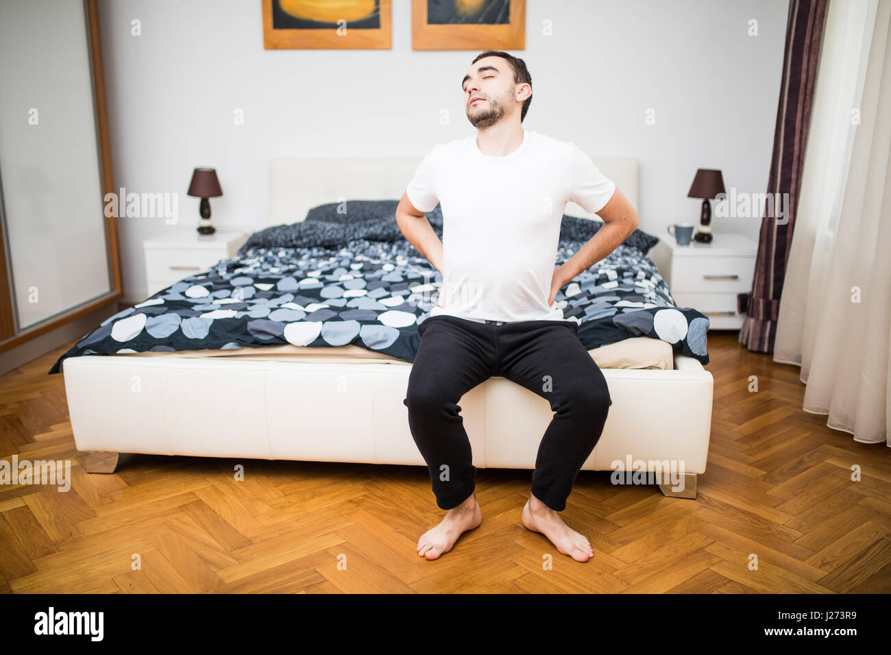 Young man in bed feels hi-res stock photography and images - Alamy