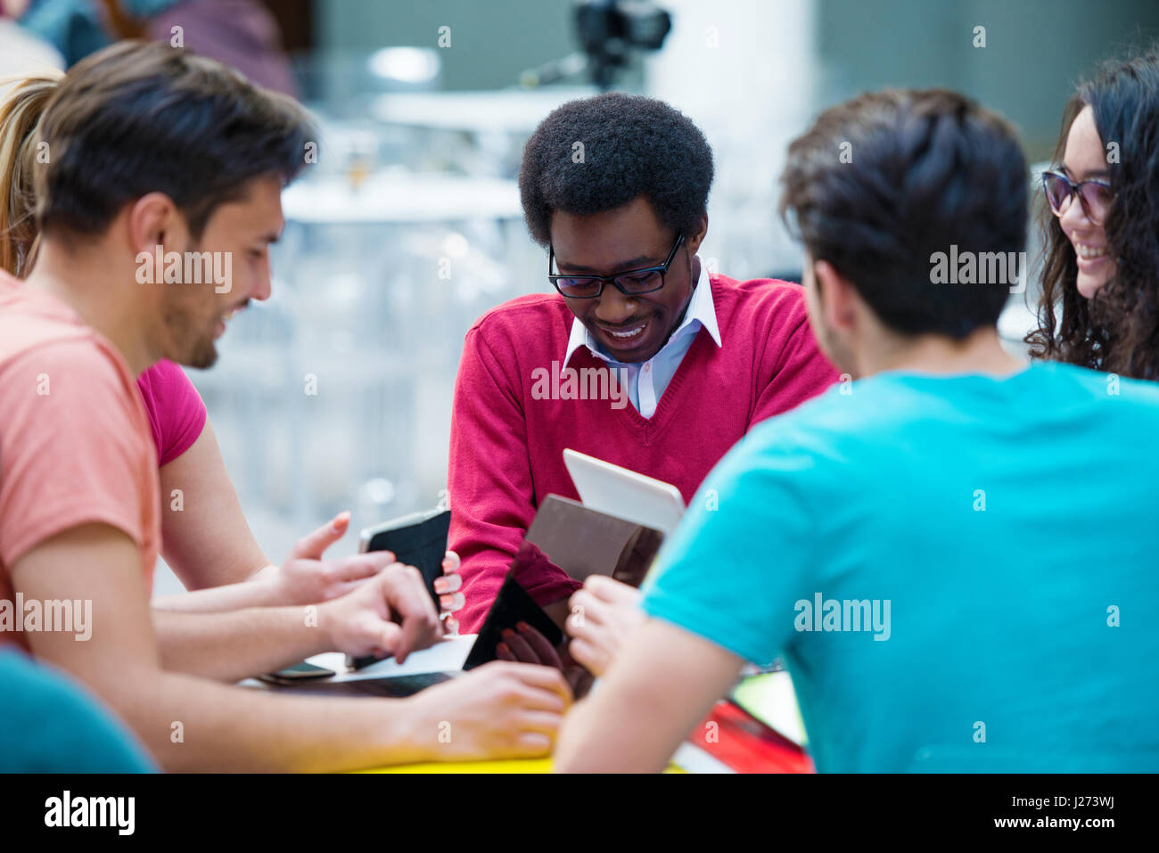 Multiracial group of young students studying together. High angle shot ...