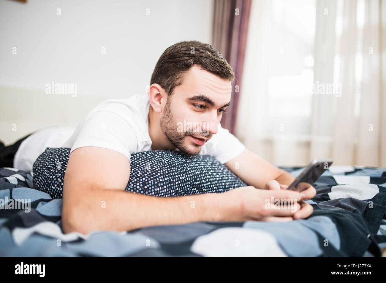 Man Texting Bed Stock Photos & Man Texting Bed Stock Images - Alamy
