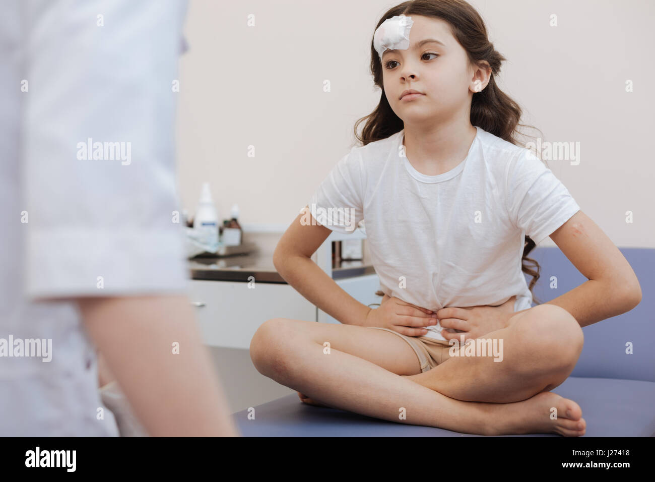 Unhappy sad girl holding her stomach Stock Photo - Alamy