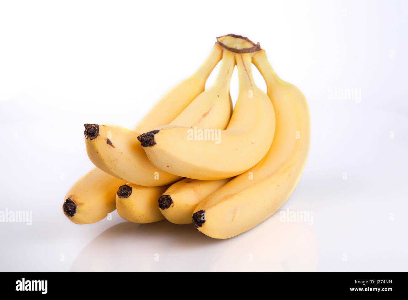 Six bananas on a white surface. Bananas isolated on white background ...