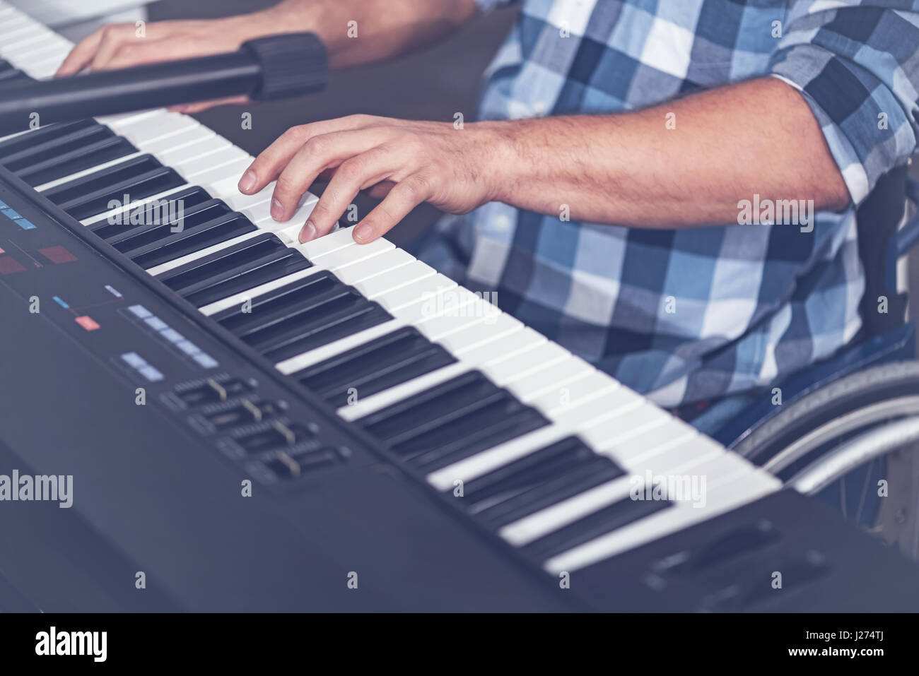 Young disabled man playing musical keyboard in the studio Stock Photo ...
