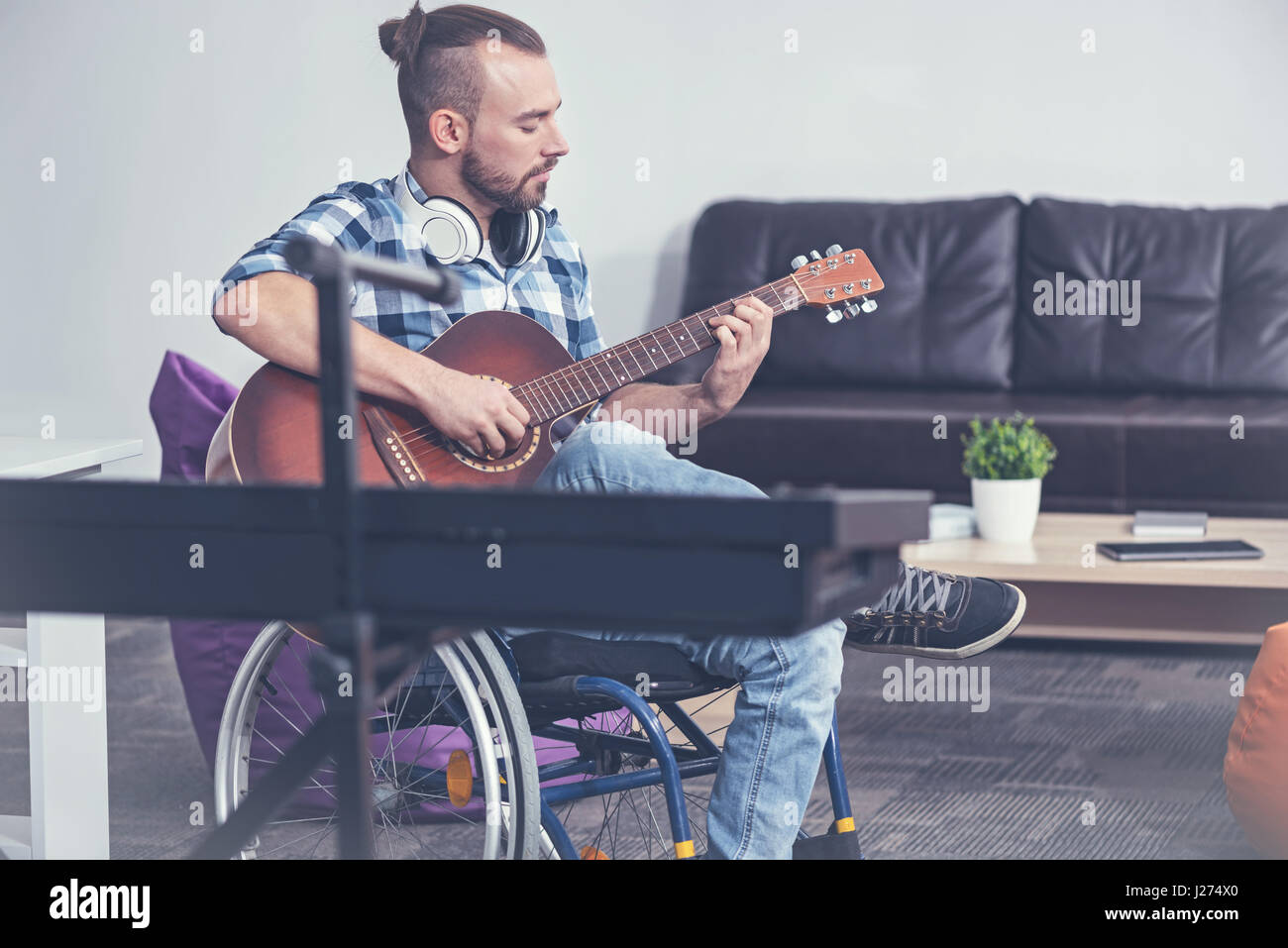 Capable handicap playing musical instrument in the studio Stock Photo ...