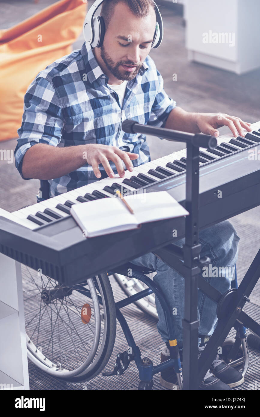 Enthusiastic disabled playing musical instrument in the recording ...